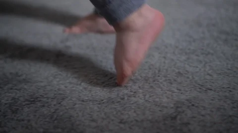 Toddler's feet learning to walk in slow ... | Stock Video | Pond5