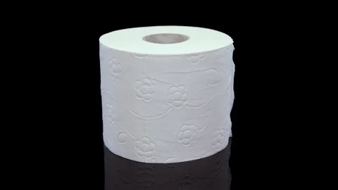 Toilet paper roll rotating on a black ba... | Stock Video | Pond5