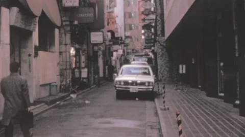 Tokyo - 1975: Pedestrians and parked car... | Stock Video | Pond5