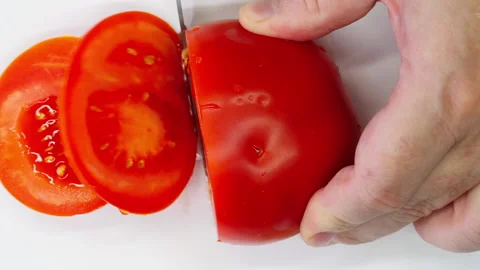 Tomato cut with a knife. Close-up. Slice... | Stock Video | Pond5