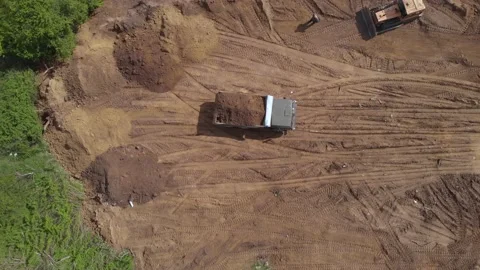 Top aerial shot: tipper pouring out soil... | Stock Video | Pond5