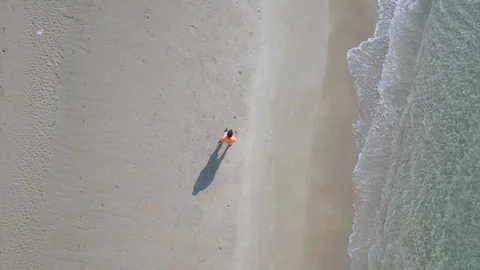 Top down aerial footage of a man walking... | Stock Video | Pond5