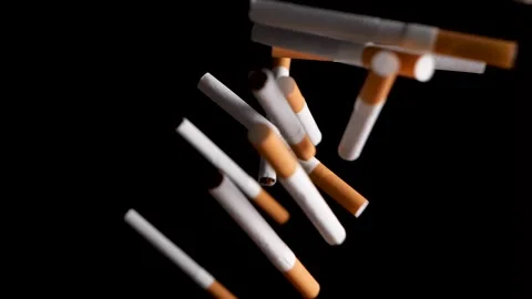 Top down shot of cigarettes falling into... | Stock Video | Pond5