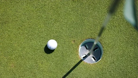 Top down shot of golf ball falling into ... | Stock Video | Pond5