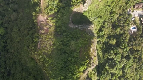 Top down, treetop view of Crouching Lion | Stock Video | Pond5