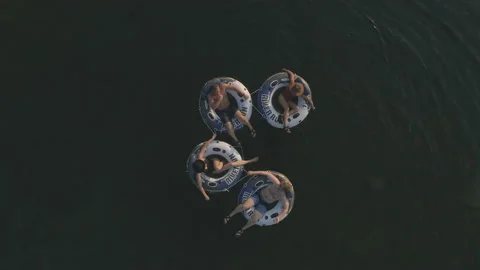 Top Down View of Friends Floating in a L... | Stock Video | Pond5