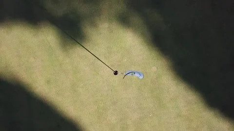Top down view of golf ball hitting hole ... | Stock Video | Pond5