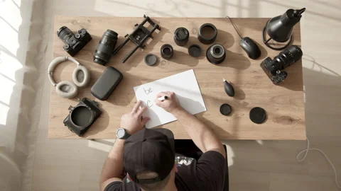 Top down view of man in black cap write ... | Stock Video | Pond5