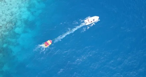 Top down view over a motor boat pulling ... | Stock Video | Pond5