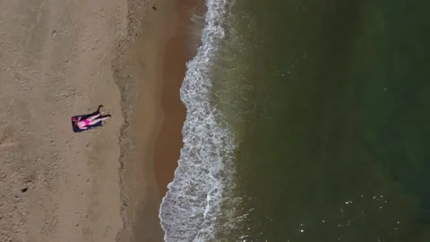 Top down view of a tourist sunbathing in... | Stock Video | Pond5