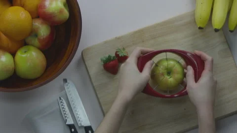 Top Down View of Using an Apple Cutter | Stock Video | Pond5