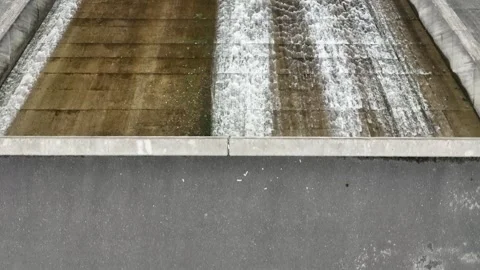 Top down view of water flowing down dam ... | Stock Video | Pond5
