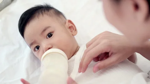 Top view, Adorable little Asian baby dri... | Stock Video | Pond5