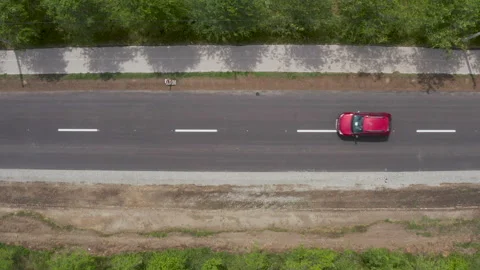 Top view aerial shot of red car on brand... | Stock Video | Pond5