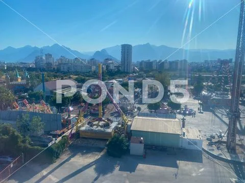 Top view of the amusement park with a ferris wheel and roller coaster ...