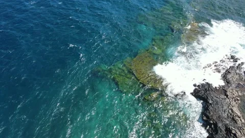 Top view of a beautiful blue ocean and a... | Stock Video | Pond5
