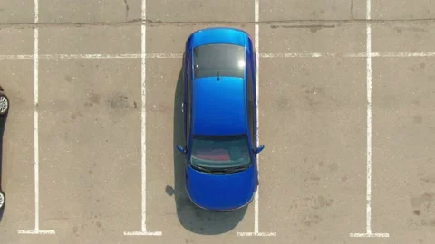 Top view blue car driving out of the par... | Stock Video | Pond5