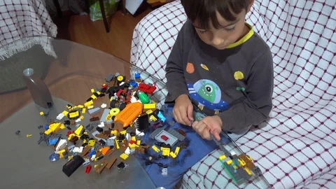 Top view Child busy with lego building b... | Stock Video | Pond5
