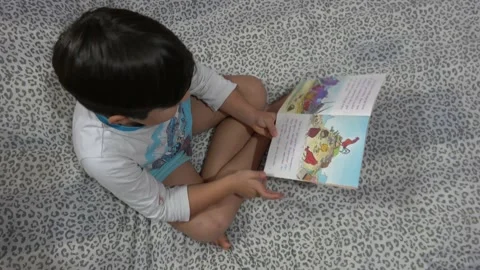 Top view a child reading a book | Stock Video | Pond5