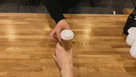 Top view. Close up of hand taking coffee... | Stock Video | Pond5