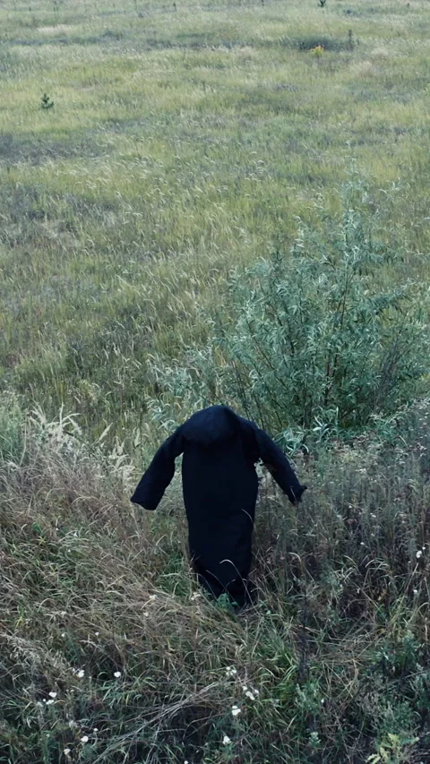 Top view of a dark spooky figure in gras... | Stock Video | Pond5