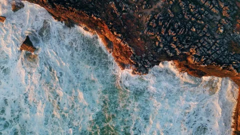 Top view foamy sea splashing under coast... | Stock Video | Pond5