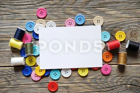 Top view frame made of colorful threads and buttons on wooden ...