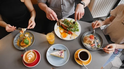 Top view friends eating food in cafe you... | Stock Video | Pond5