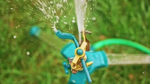 Top view of garden sprinkler spreading f... | Stock Video | Pond5