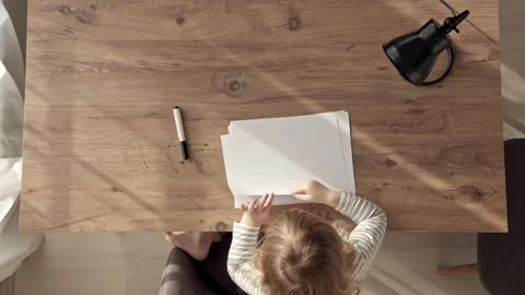 Top view of girl at her desk, picking up... | Stock Video | Pond5