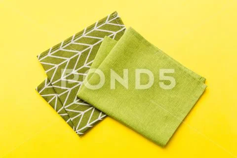 Top view with green kitchen napkin isolated on table background. Folded ...
