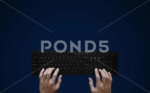 Photograph: Top view, Hand typing computer keyboard on blue background #107647392
