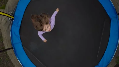 Top view of a jumping girl from a drone.... | Stock Video | Pond5
