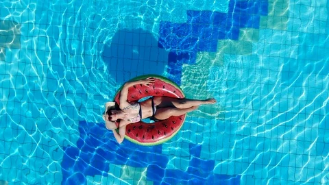 Top view of a lady sunbathing in the swi... | Stock Video | Pond5