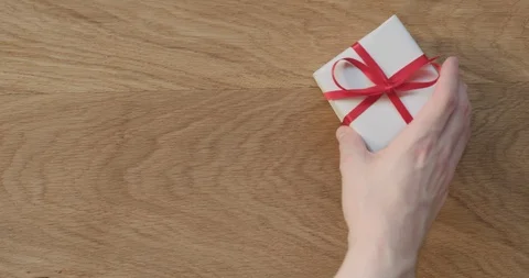 top view man hand put gift box with red ... | Stock Video | Pond5