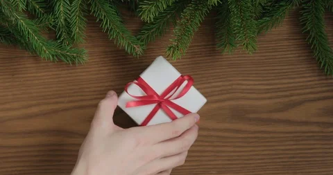 Top view man hand put gift box with red ... | Stock Video | Pond5