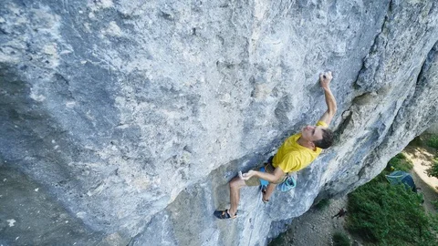 top view of man rock climber in yellow t... | Stock Video | Pond5