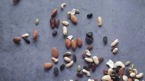 top view of many mixed nuts falling on b... | Stock Video | Pond5