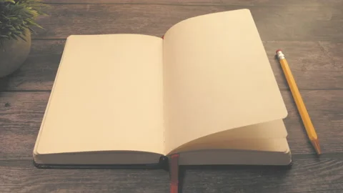 Top view of open diary and yellow color ... | Stock Video | Pond5