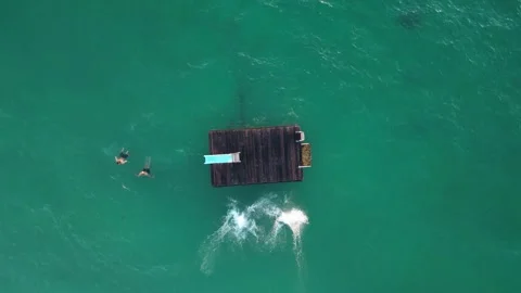 Top view of people jumping off a floatin... | Stock Video | Pond5