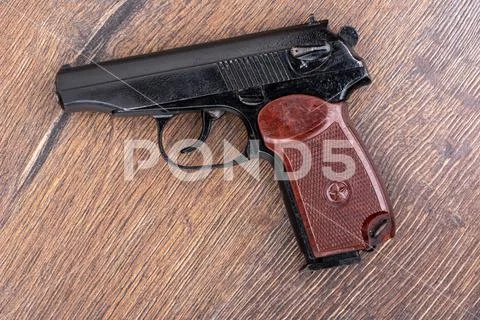 Top view of a pistol of the makarov system on a wooden background ...