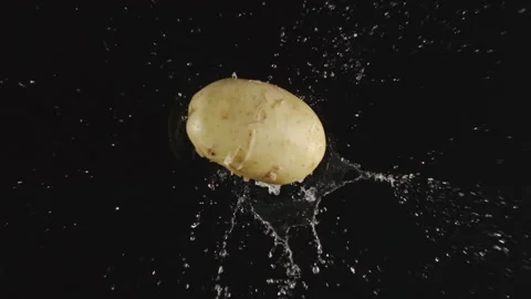 TOP VIEW: Potato falls in a water, splas... | Stock Video | Pond5