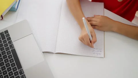 Top view of schoolboy doing homework at ... | Stock Video | Pond5