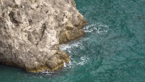 Top view of sea waves hitting rocks on t... | Stock Video | Pond5