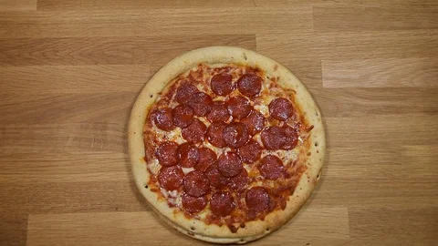 Top view shot of Pepperoni Pizza slid on... | Stock Video | Pond5
