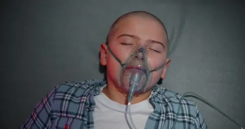 Top view of sick unconscious kid with ox... | Stock Video | Pond5