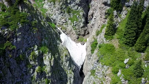 Top view of steep mountain cliffs and an... | Stock Video | Pond5