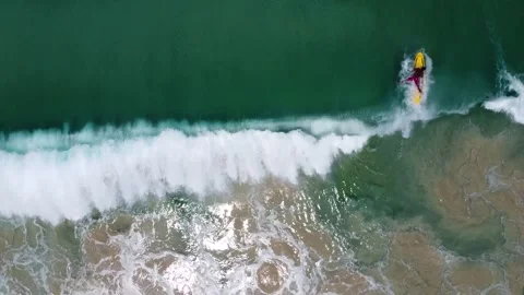 top view of a surfer who is being hit by... | Stock Video | Pond5