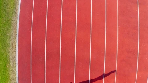 Top view of a track runner athlete runni... | Stock Video | Pond5