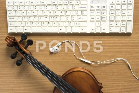 Top view of violin with computer keyboard and earphone ~ Hi Res #64118988